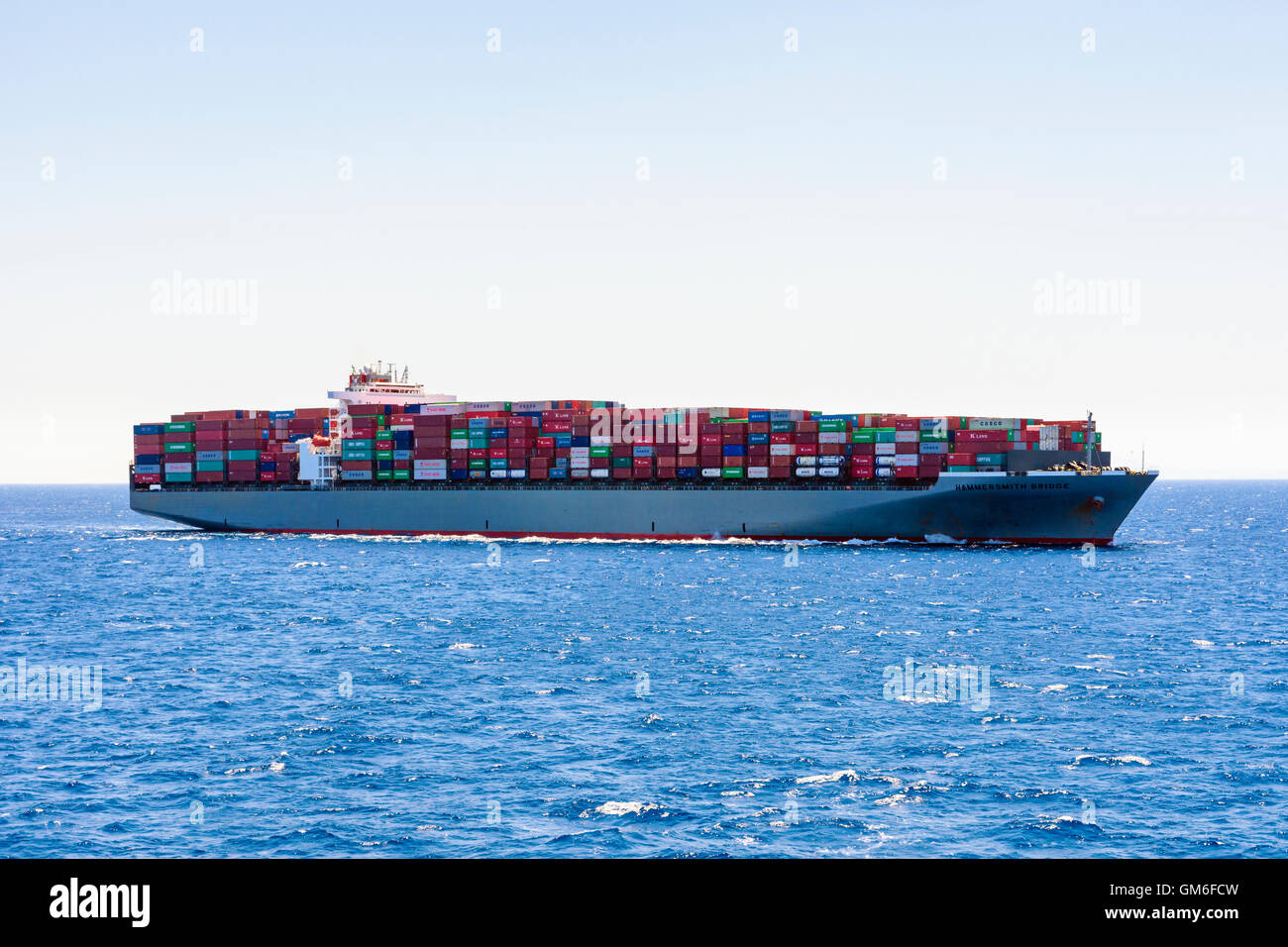 The fully loaded container ship Hammersmith Bridge in the Aegean Sea ...