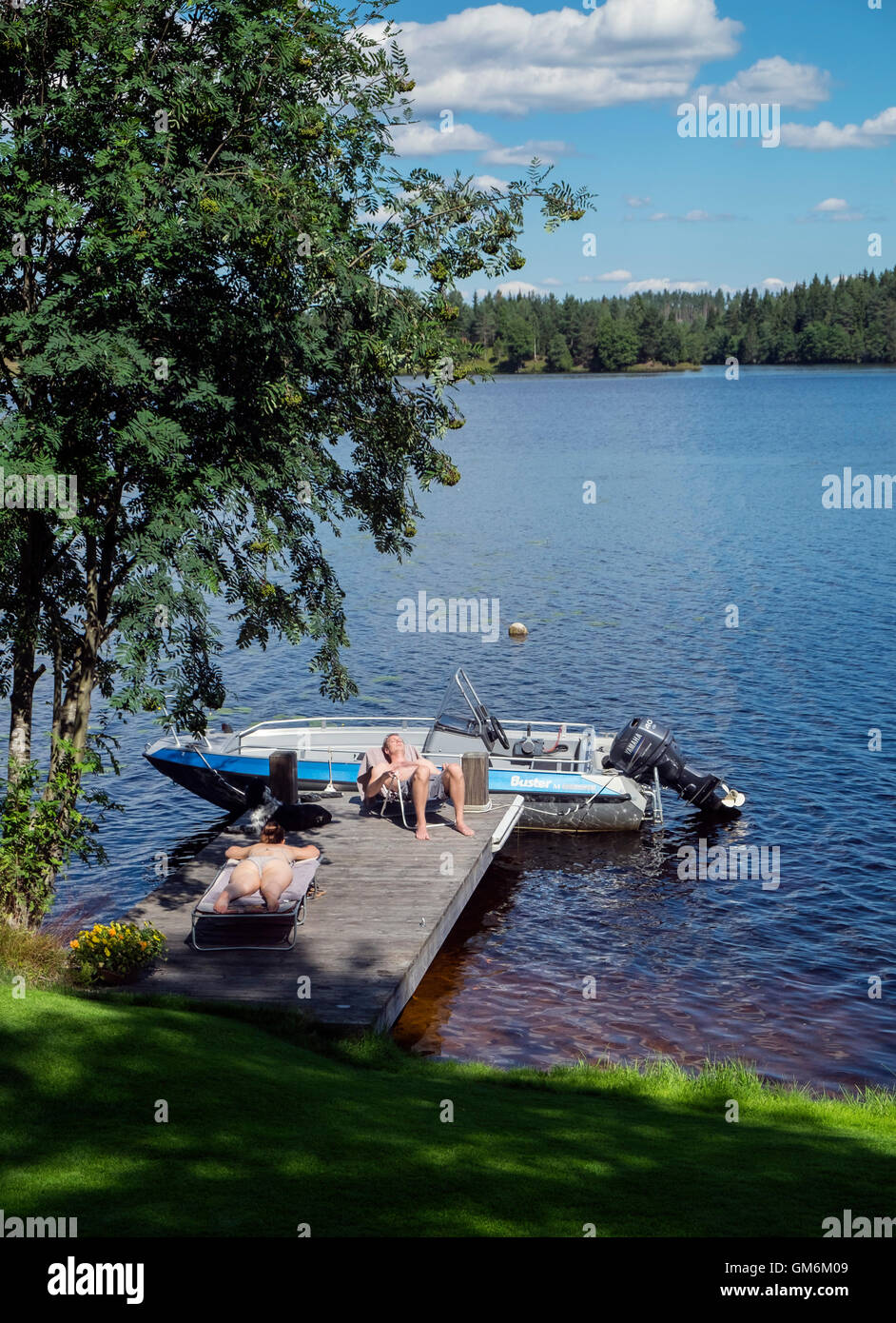 Sunbath on jetty, Sweden Stock Photo - Alamy