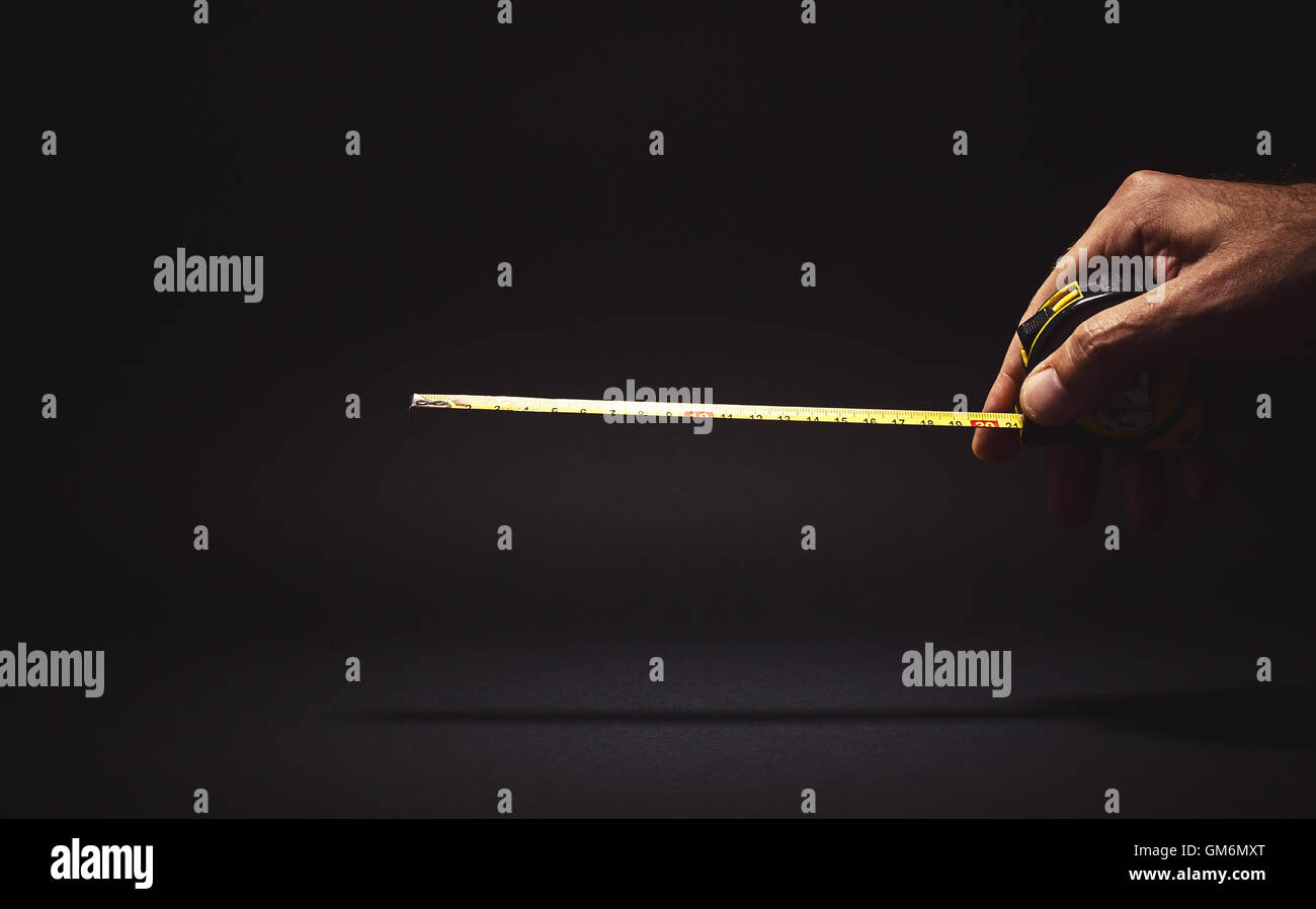 Conceptual composition representing measurements, male hand holding a ...