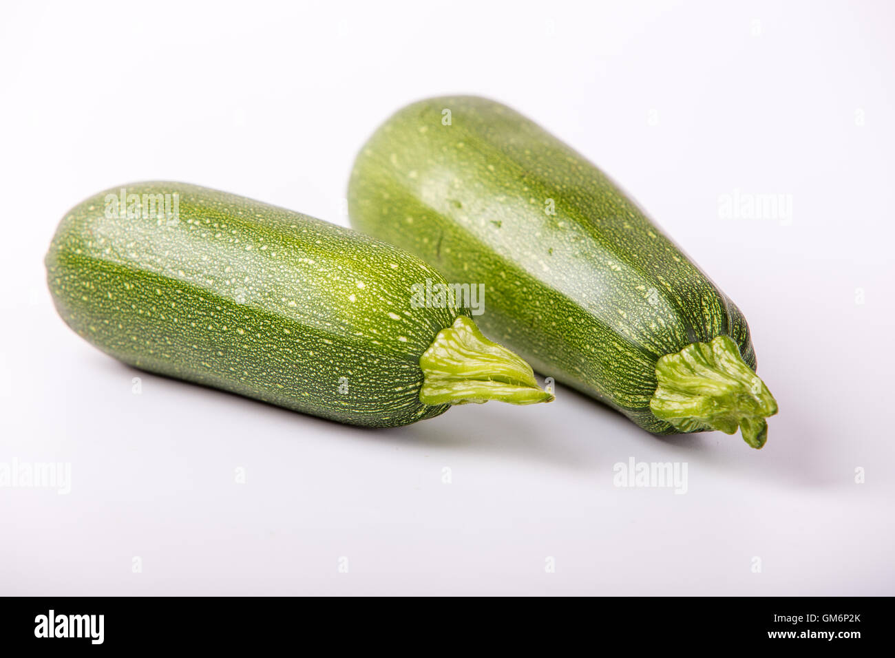 Two fresh vegetable zucchini isolated on white Stock Photo - Alamy