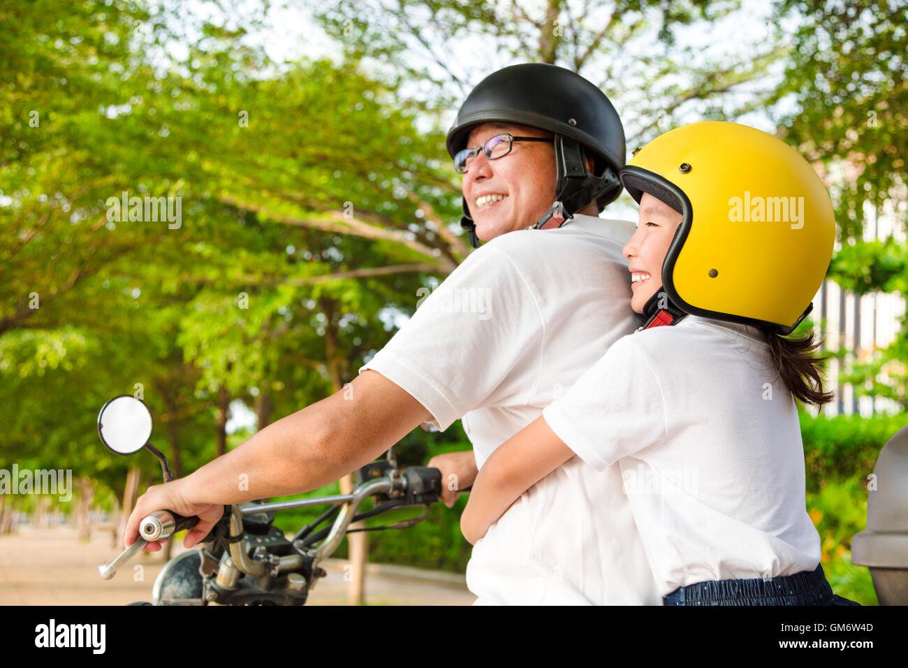Father and daughter traveling on motorcycle Stock Photo - Alamy