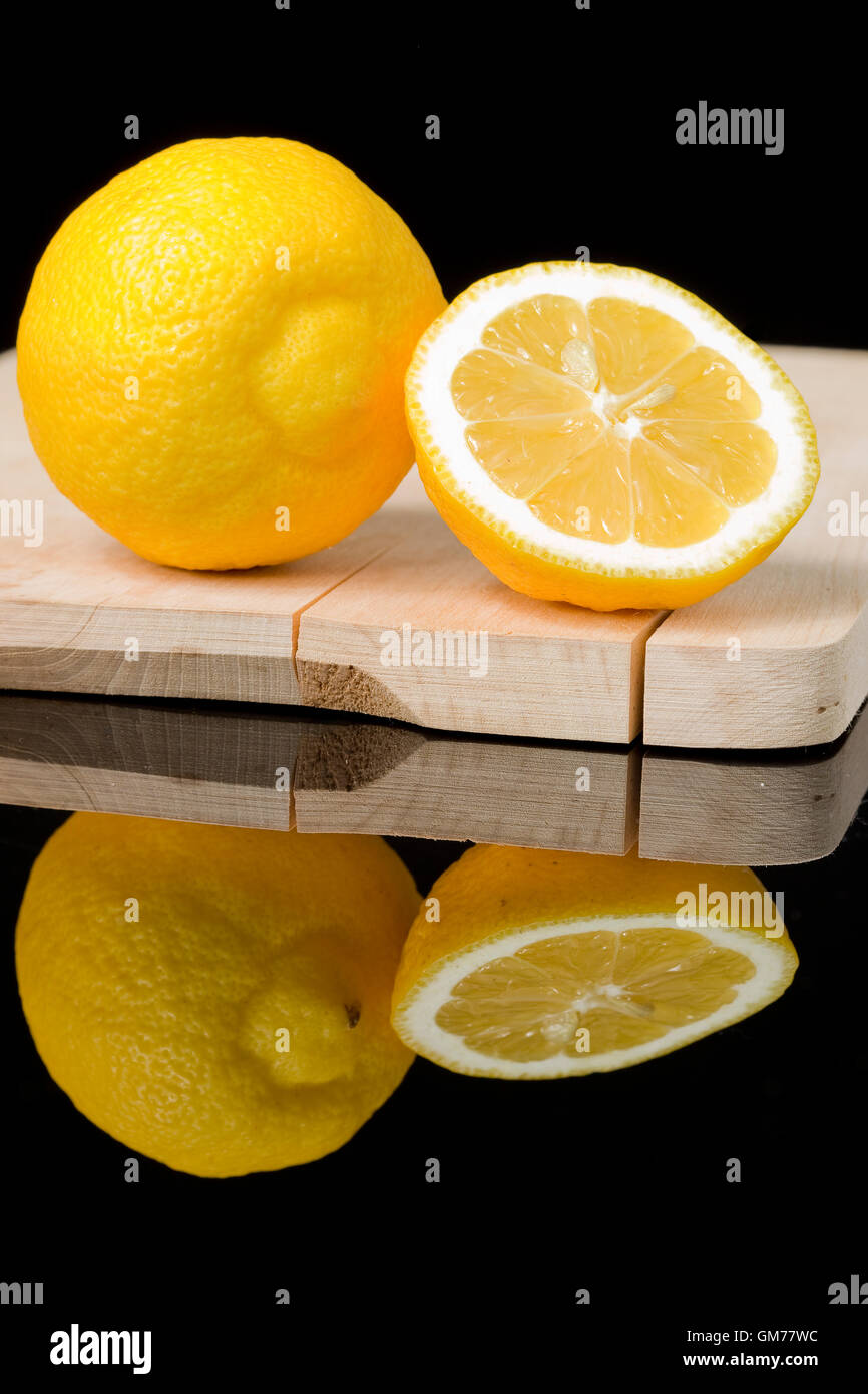 lemon on wood table with black background Stock Photo - Alamy