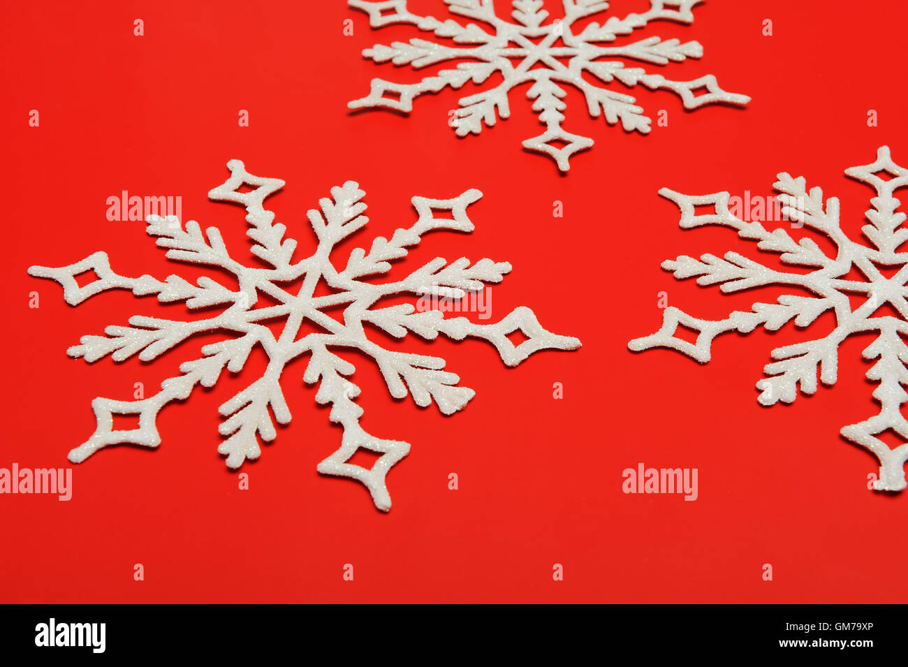 The big snowflake on a red background Stock Photo - Alamy