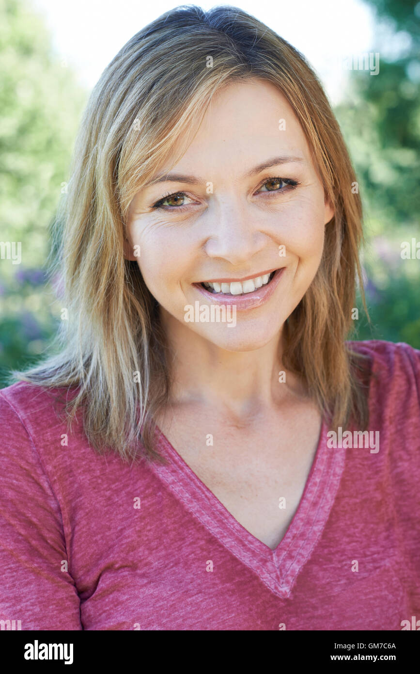 Outdoor Head And Shoulders Portrait Of Smiling Mature Woman Stock Photo ...