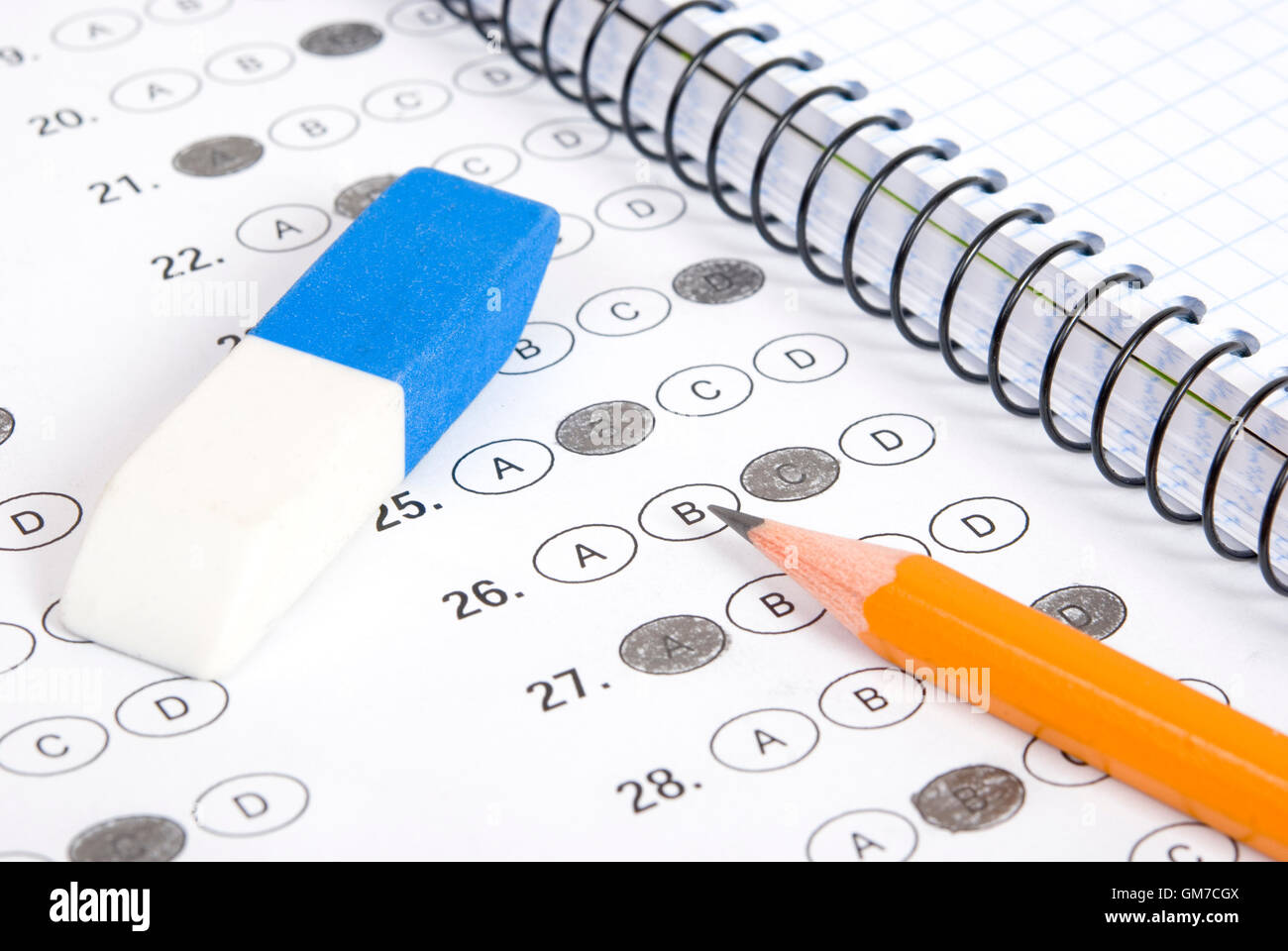 Test score with pencil, notebook and eraser Stock Photo - Alamy