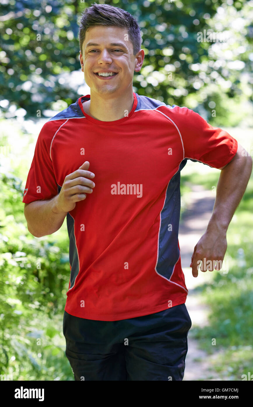 Young men running in park hi-res stock photography and images - Alamy