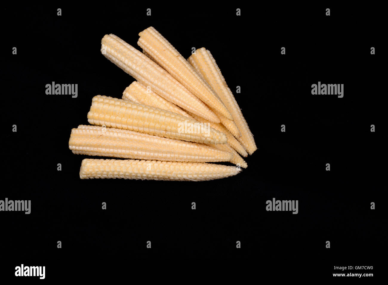 Baby corn on black background Stock Photo - Alamy