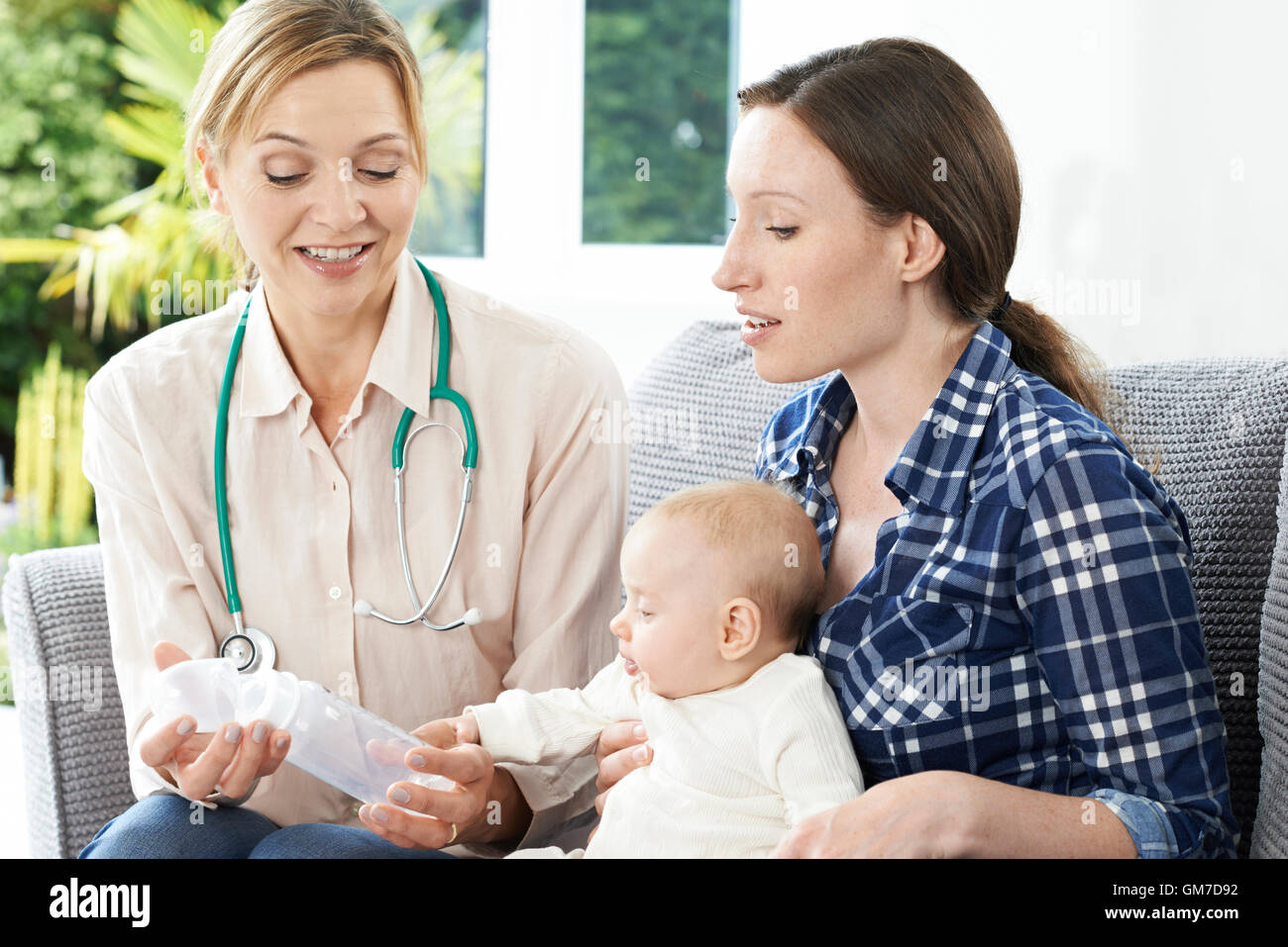 Health Visitor Giving Mother Advice On Feeding Baby With Bottle Stock ...