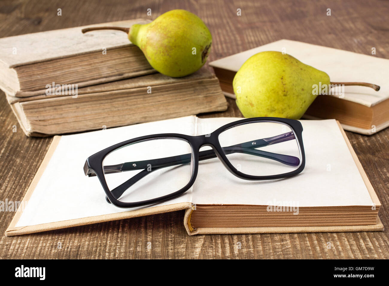 Still life with books, glasses and pears Stock Photo - Alamy
