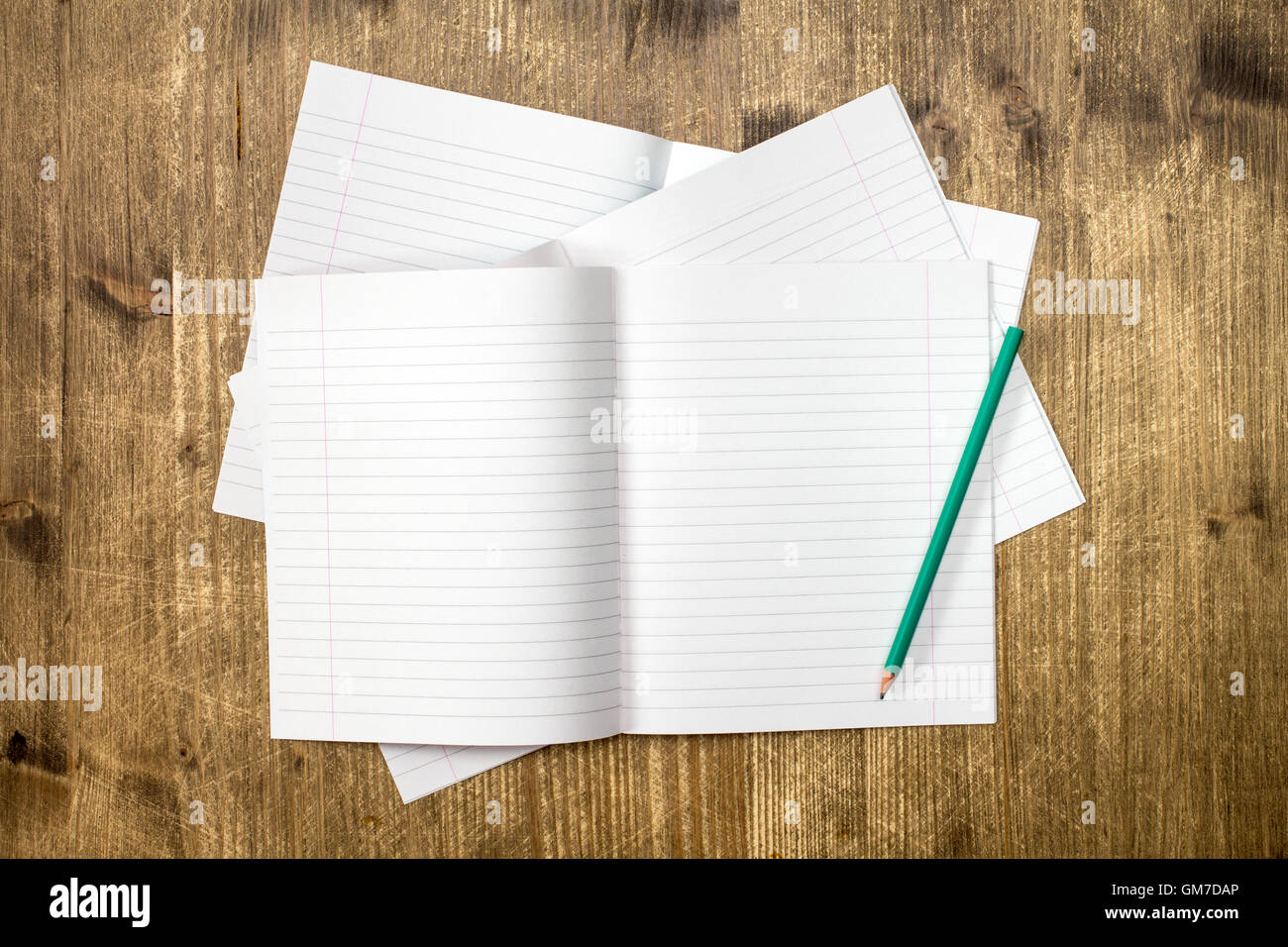 Open white lined exercise books and pencil on wooden table Stock Photo ...