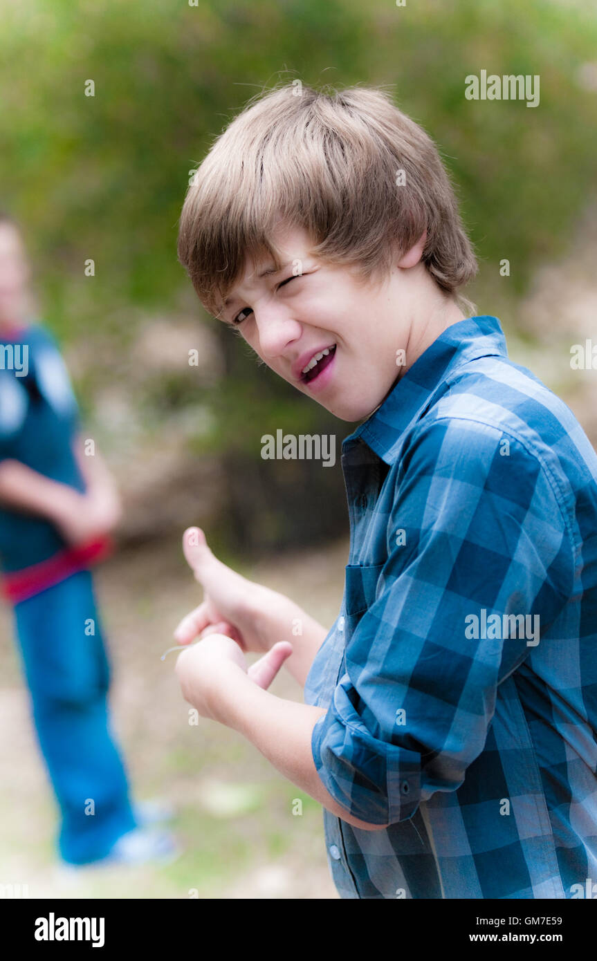 Young boy pointing backwards Stock Photo - Alamy