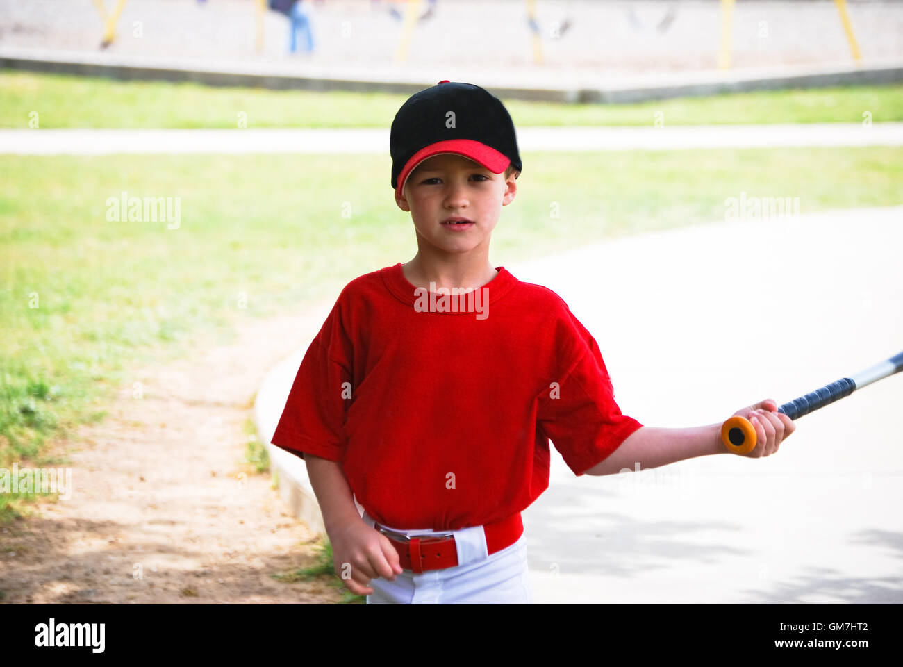 Little baseball player holding bat Stock Photo - Alamy