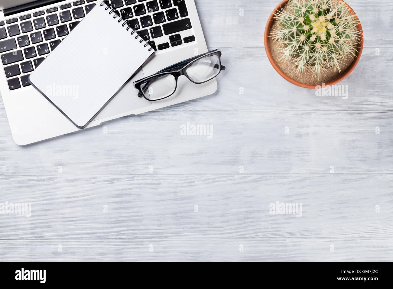 Desk table with laptop and notepad on wooden table. Workplace. Top view ...