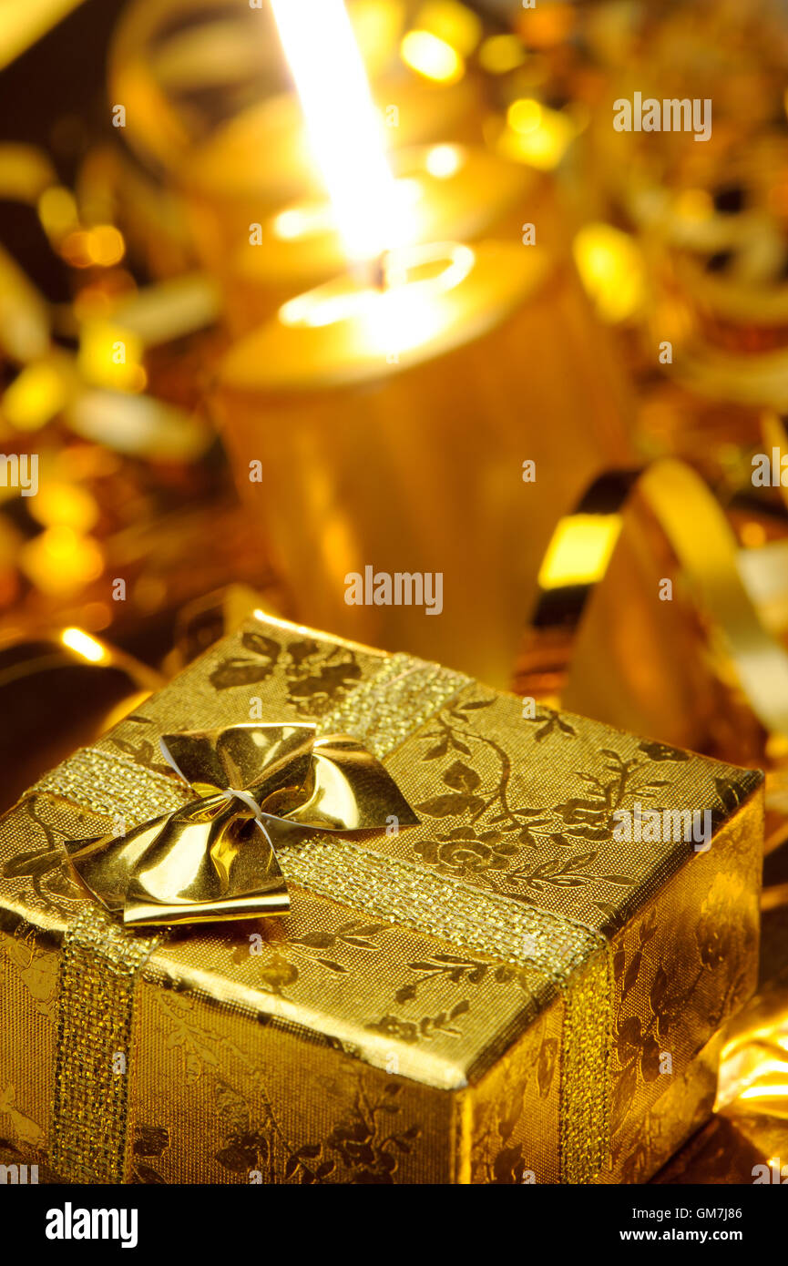 Gold christmas candles and gold gift boxes Stock Photo - Alamy