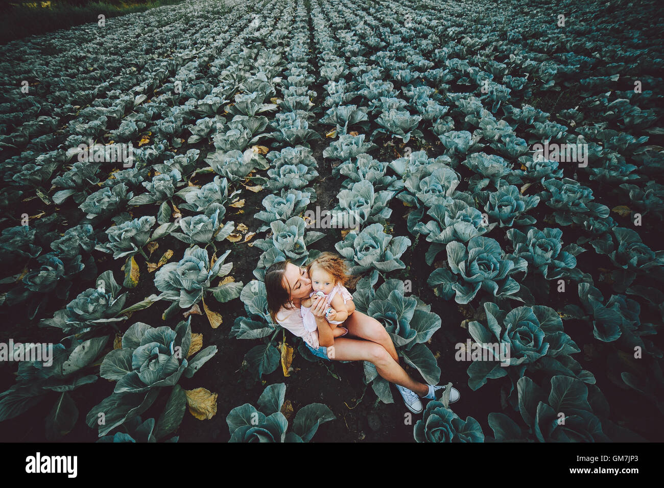 Mother and daughter on the field with cabbage Stock Photo - Alamy