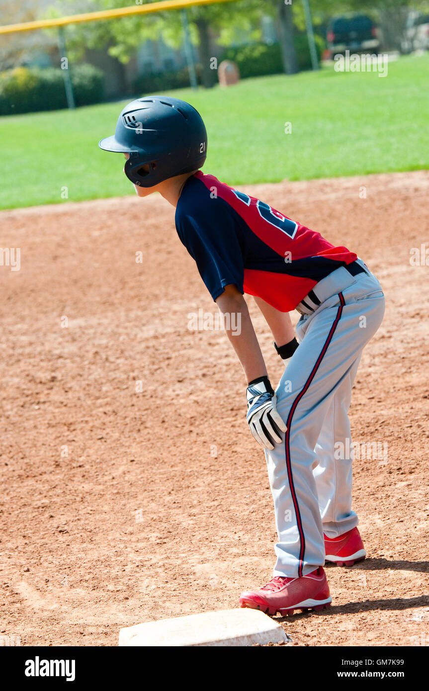Teen baseball boy on base Stock Photo - Alamy
