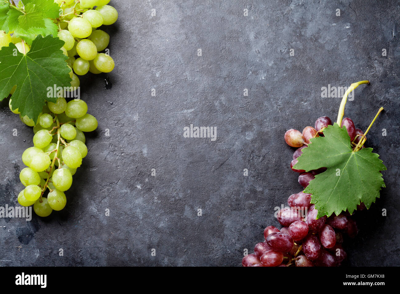 Red and white grapes over stone table. Top view with copy space Stock ...