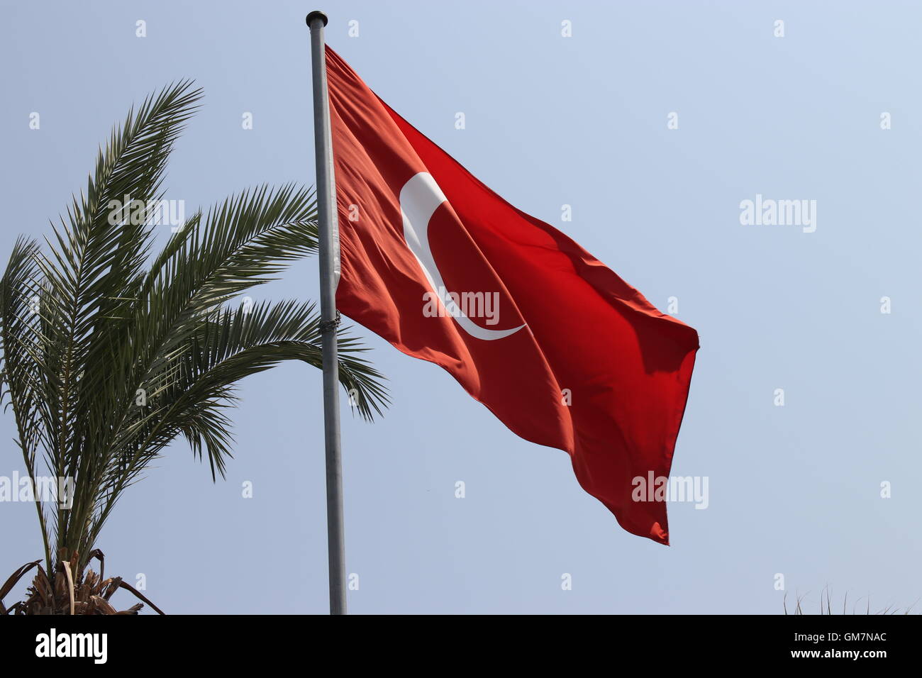 The national flag of turkey flying on a post against a blue sky Stock ...