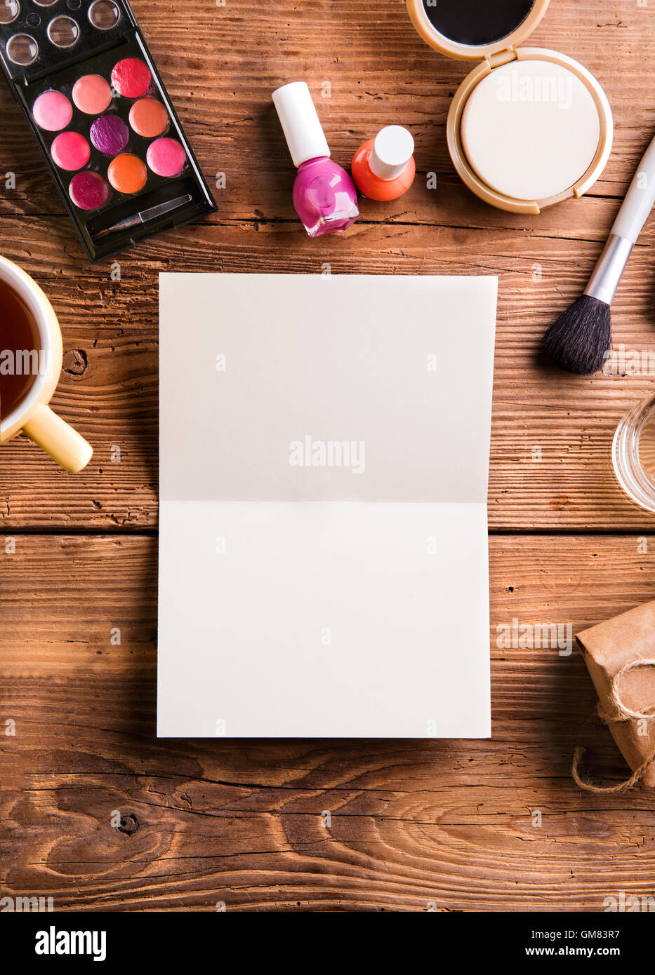 Empty greeting card laid on table. Make up products Stock Photo - Alamy
