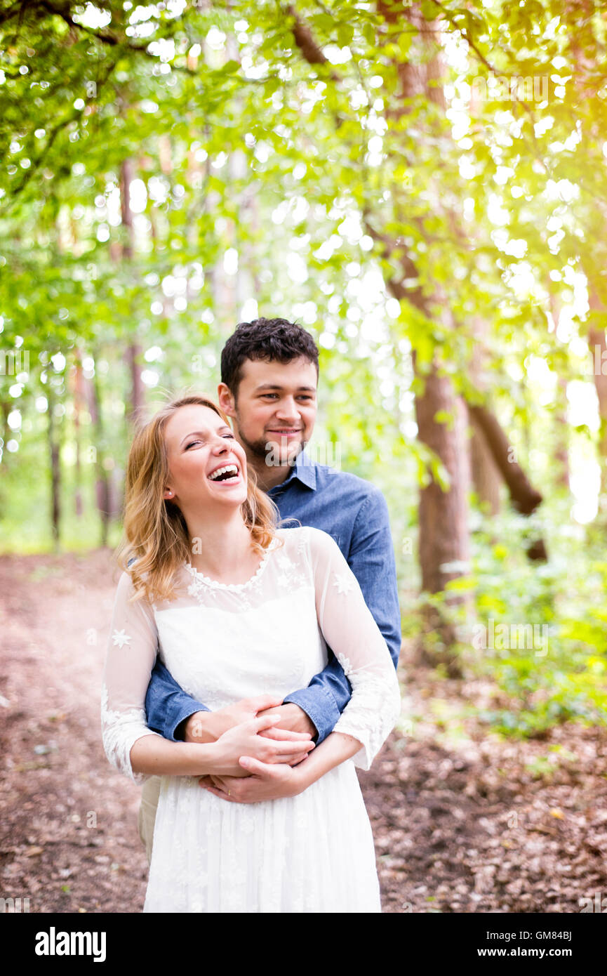 Beautiful wedding couple outside in green forest Stock Photo - Alamy