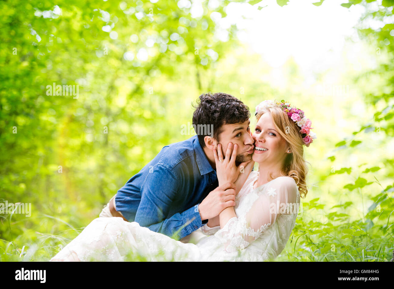 Beautiful wedding couple outside in green forest Stock Photo - Alamy