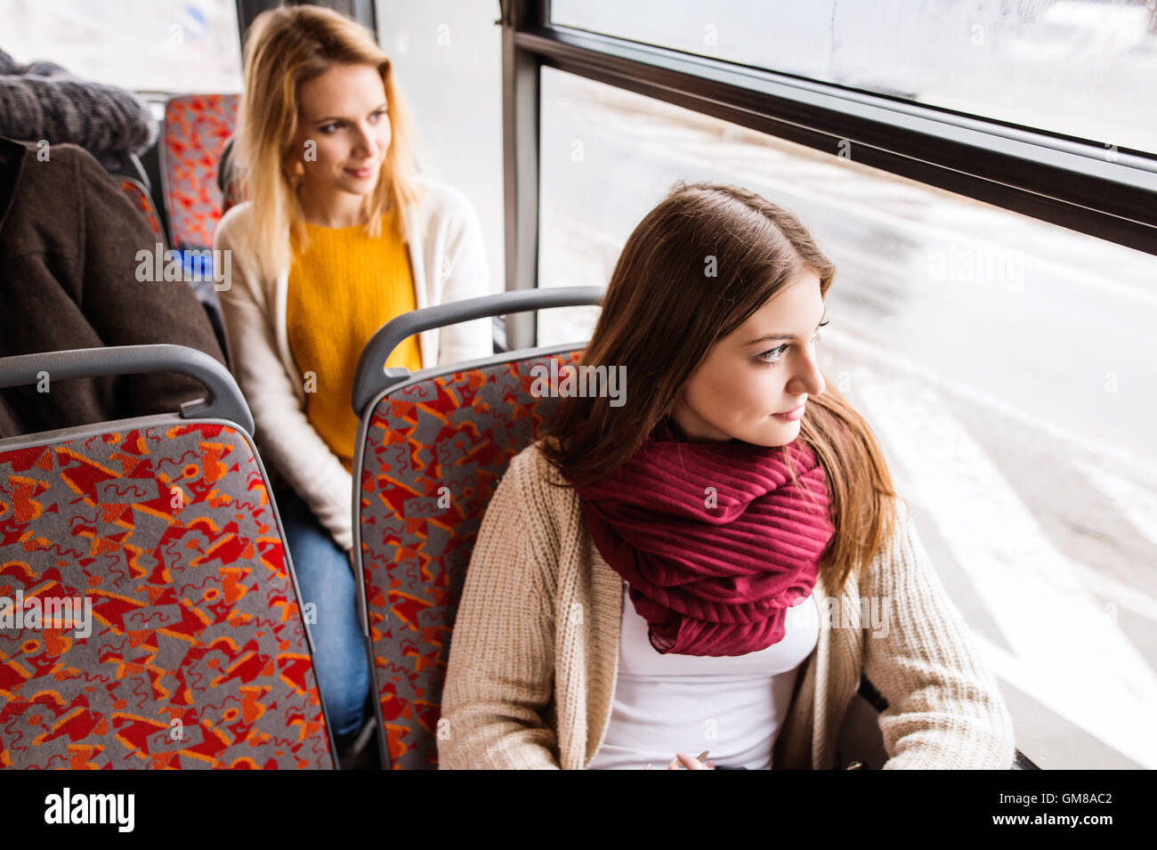 Beautiful young women traveling by bus, having fun Stock Photo - Alamy