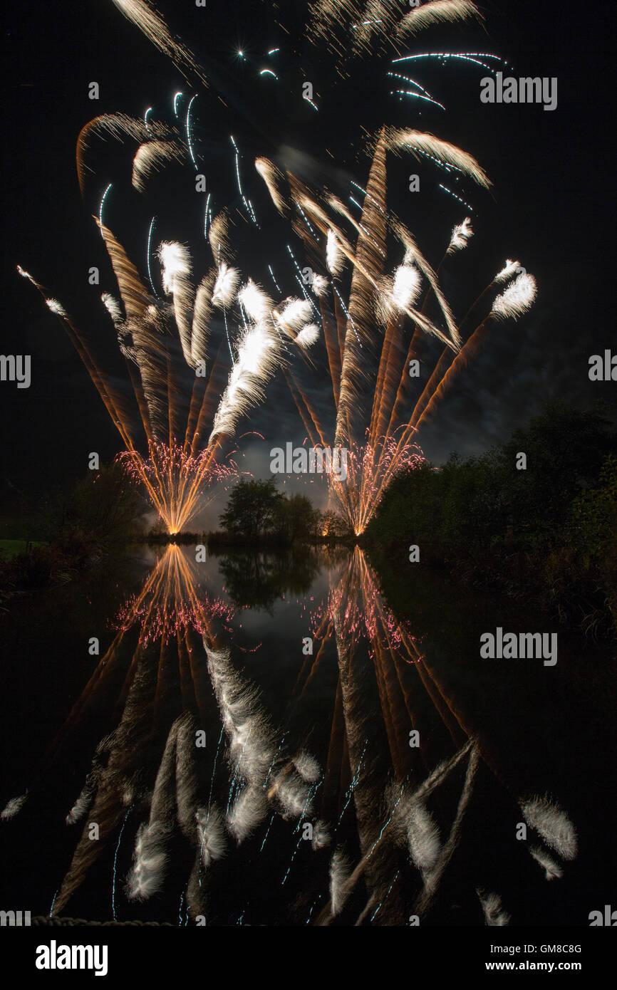 Spectacular and colourful firework display set against a dark Autumn ...