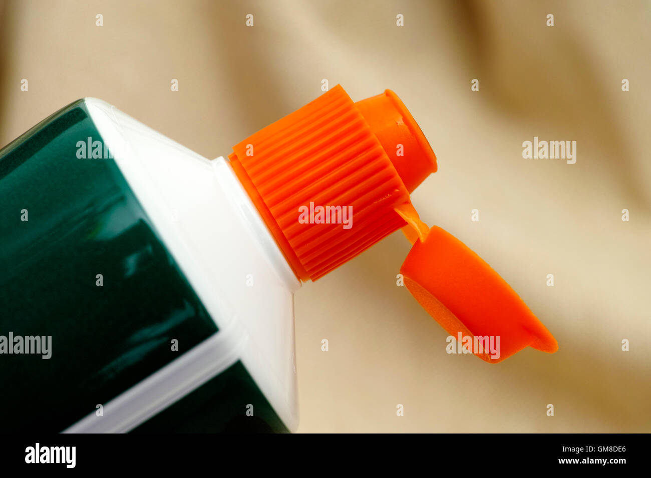 Open orange cap of toothpaste tube. Close-up Stock Photo - Alamy