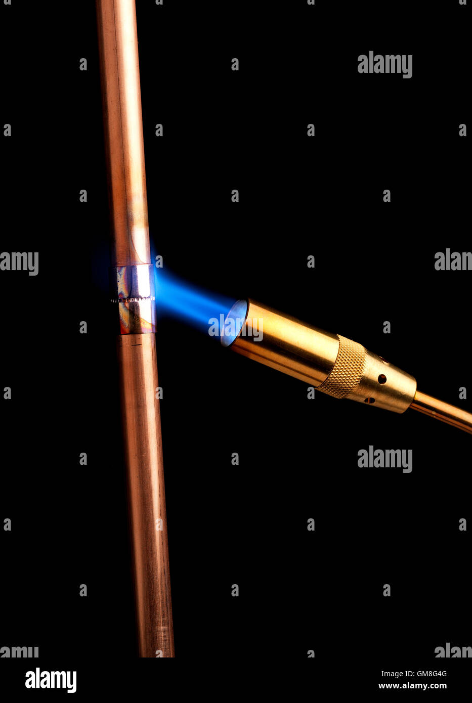 Blowtorch with flame on a black background Stock Photo - Alamy