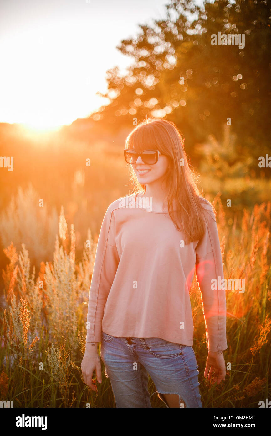 Portrait of young modern girl on the background of nature. Young woman ...