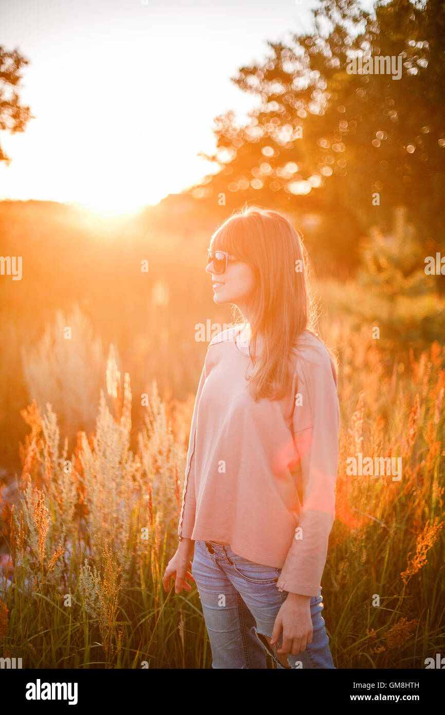 Portrait of young modern girl on the background of nature. Young woman ...