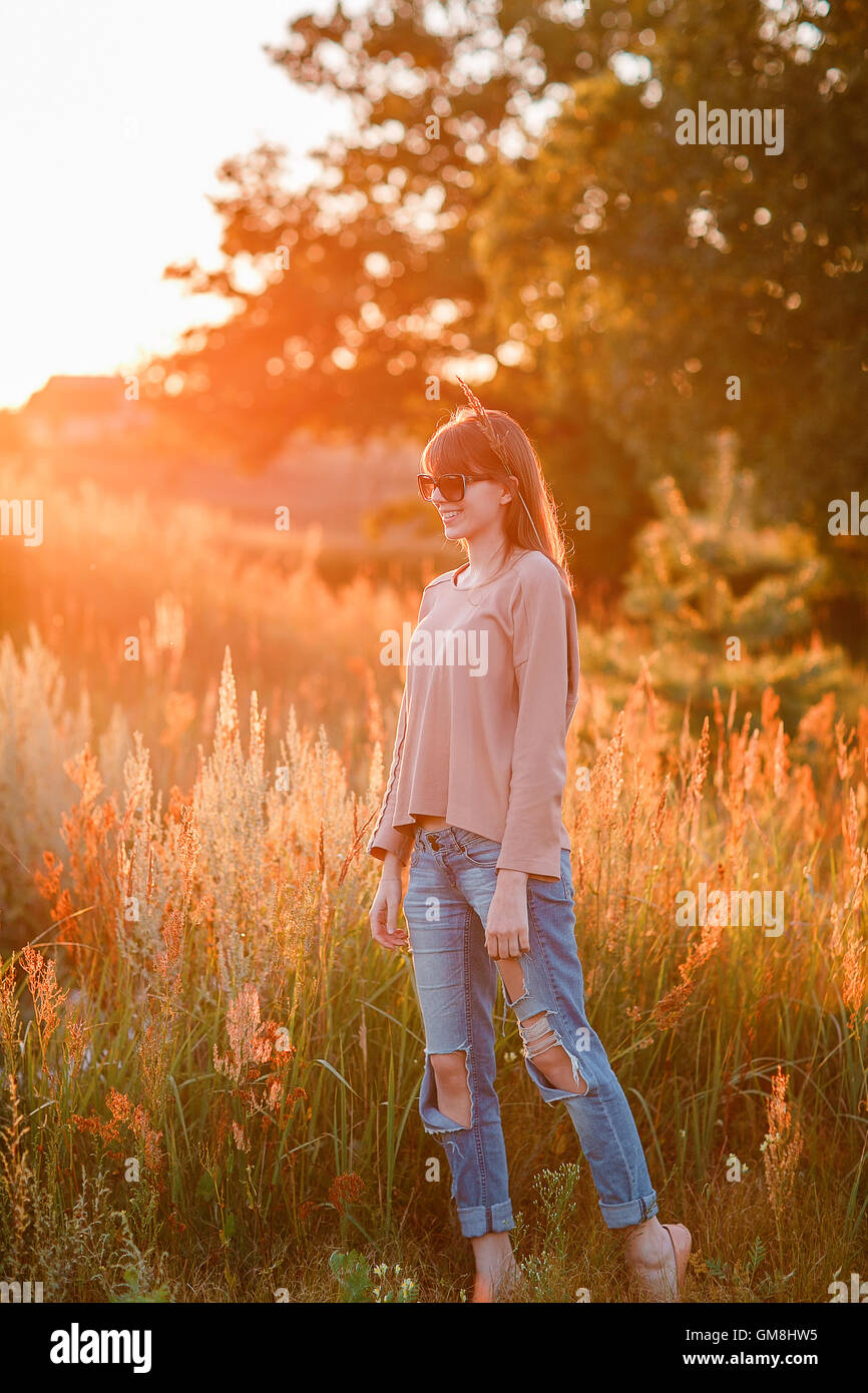 young modern girl on background sunset Stock Photo - Alamy