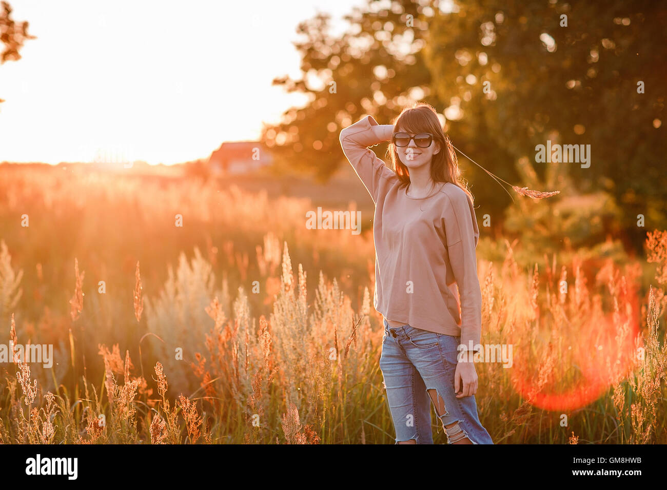 young modern girl on background sunset Stock Photo - Alamy