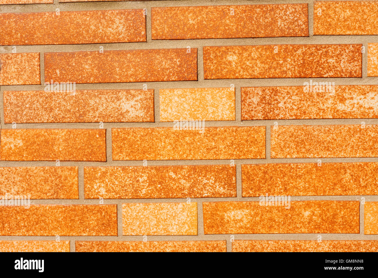 Fake ocher brick wall siding Stock Photo - Alamy