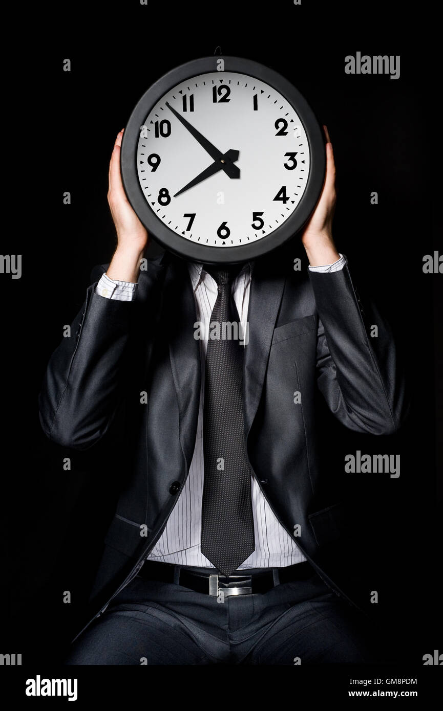 man holding clock Stock Photo - Alamy