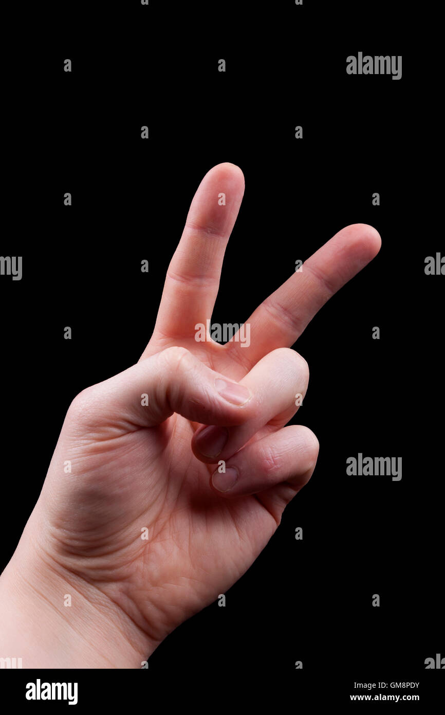 Hand with peace sign on black background Stock Photo - Alamy