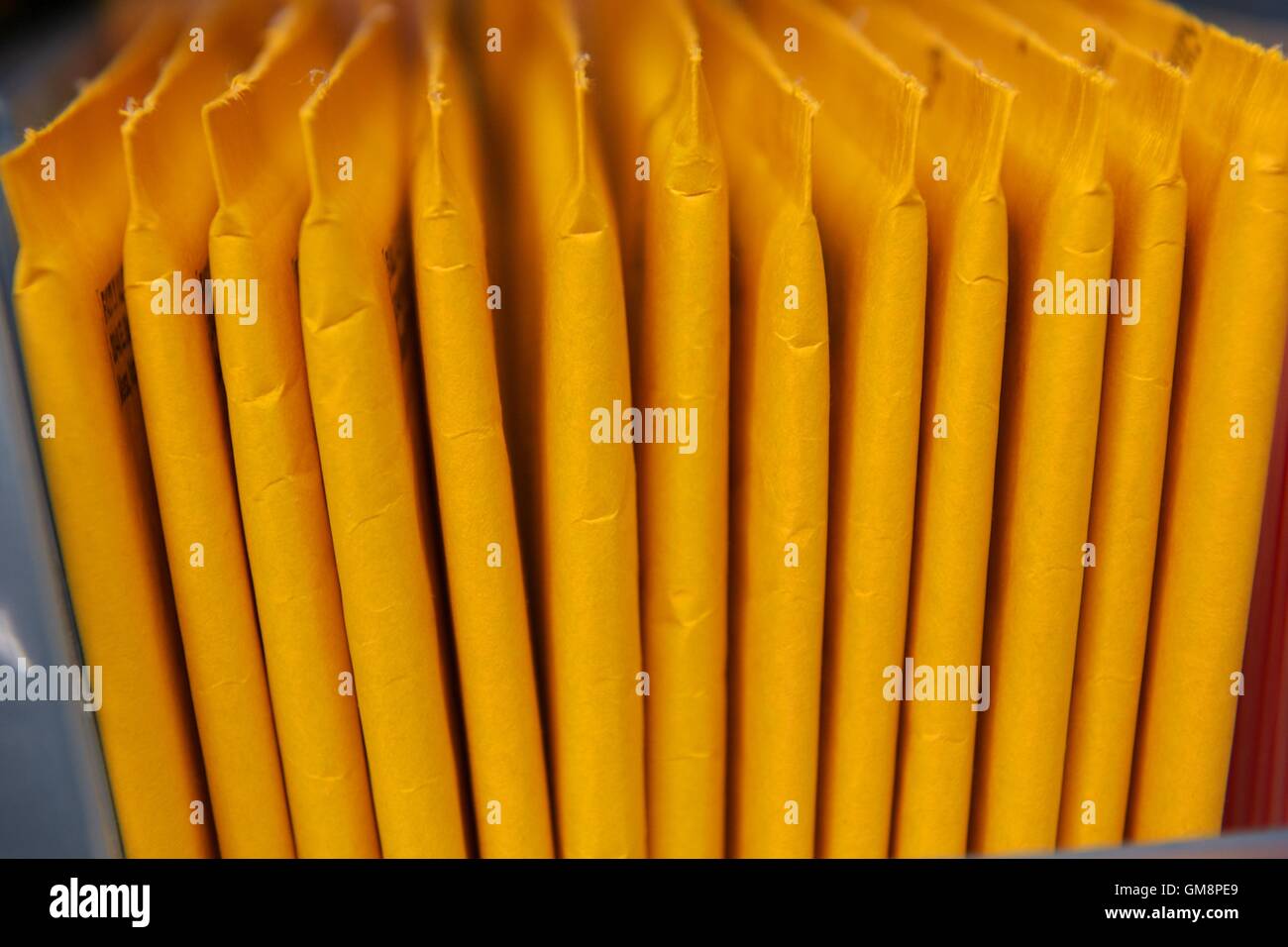 Yellow Stuffed Envelopes in a Row Stock Photo - Alamy