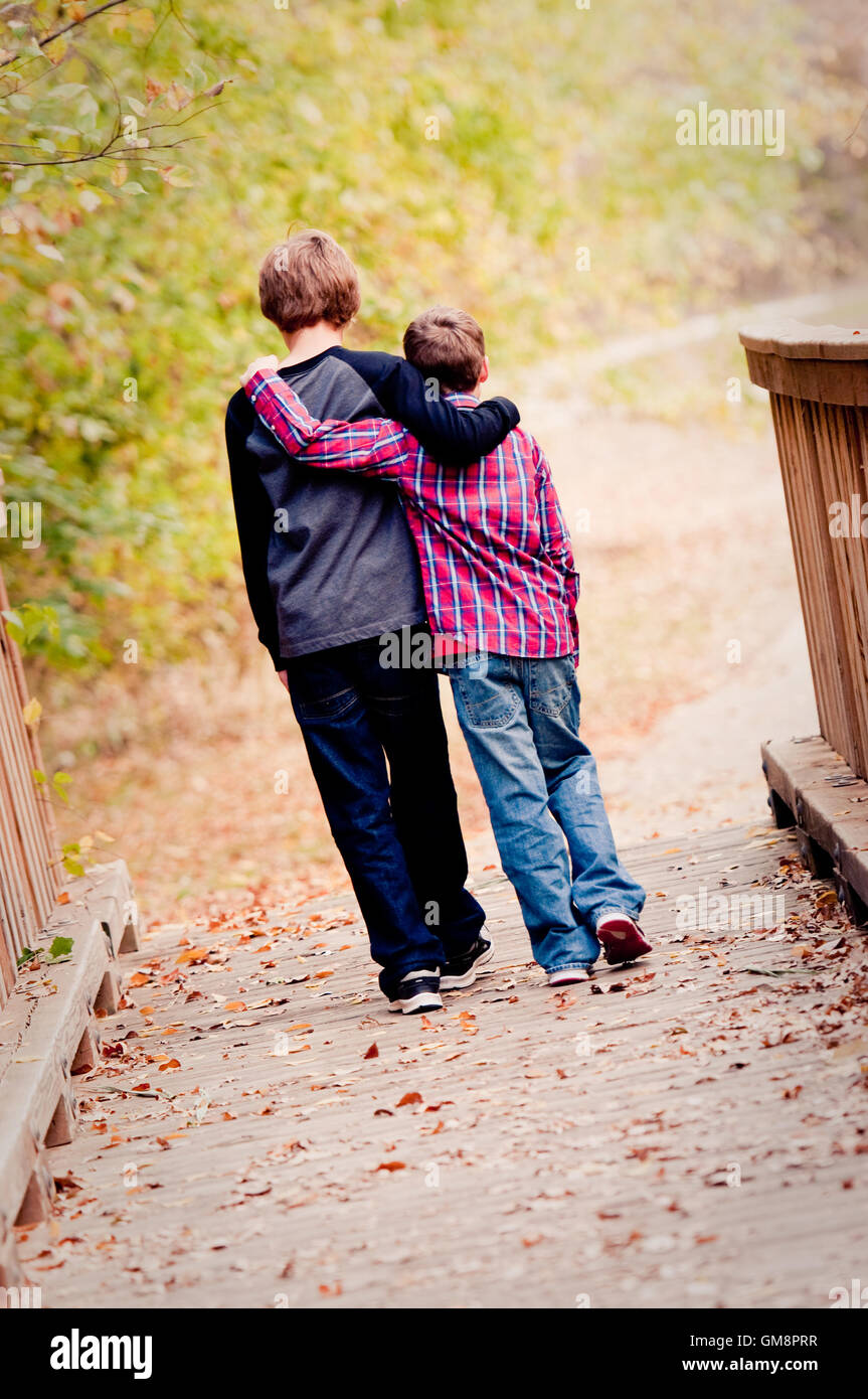 Two brothers hugging walking on hi-res stock photography and images - Alamy