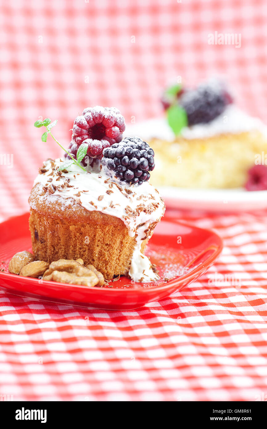muffin with whipped cream, cake with icing, raspberry, blackberr Stock ...