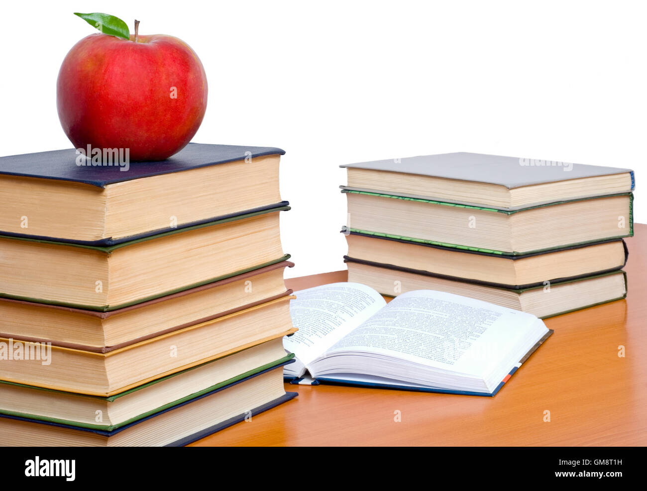 Books tower with apple isolated on white Stock Photo - Alamy