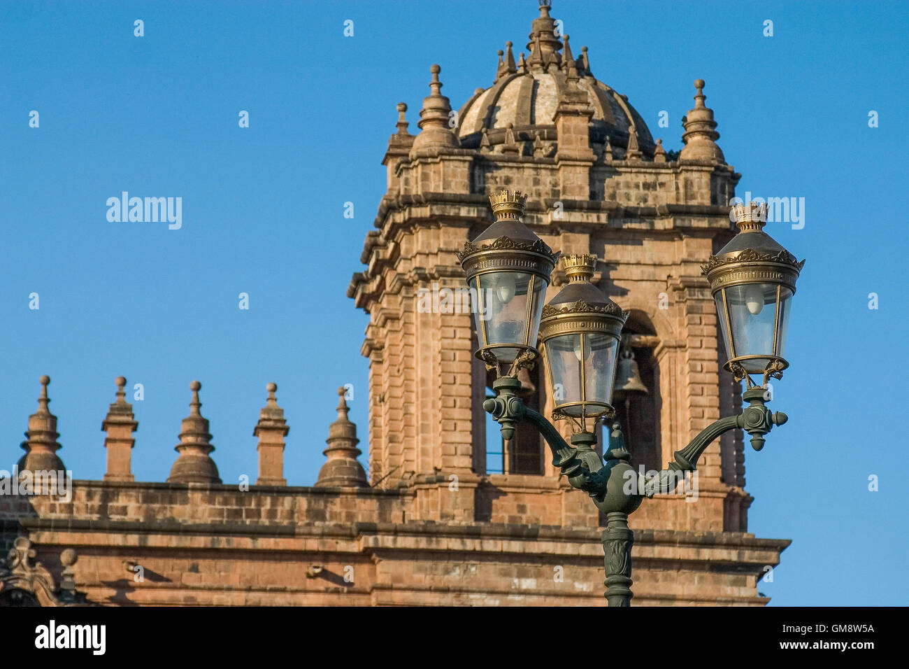 A street lamp in front of a bell tower Stock Photo - Alamy