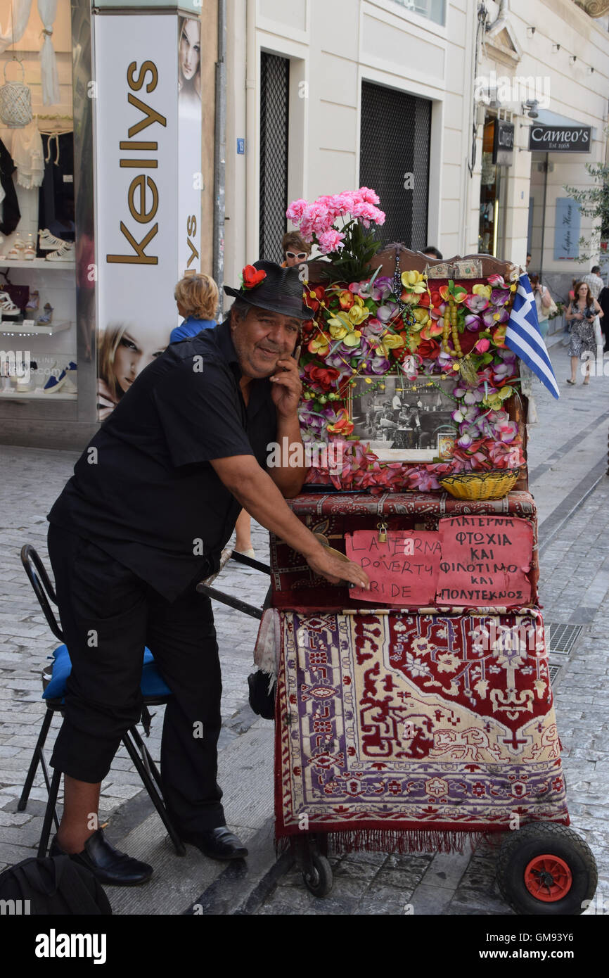 Man playing traditional laterna portable barrel piano. Street musician ...