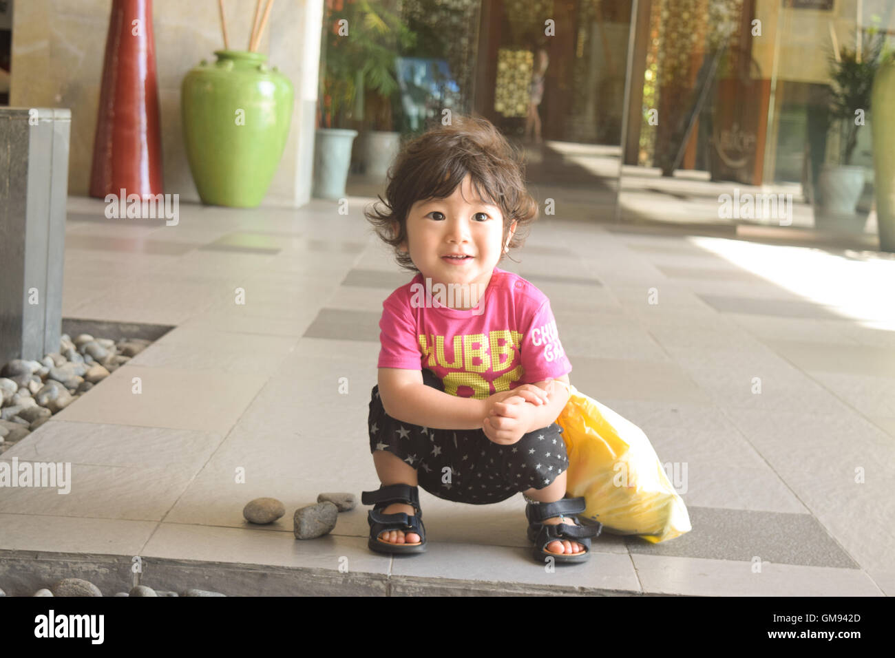 walking child sunny day at outer place smiling Stock Photo - Alamy