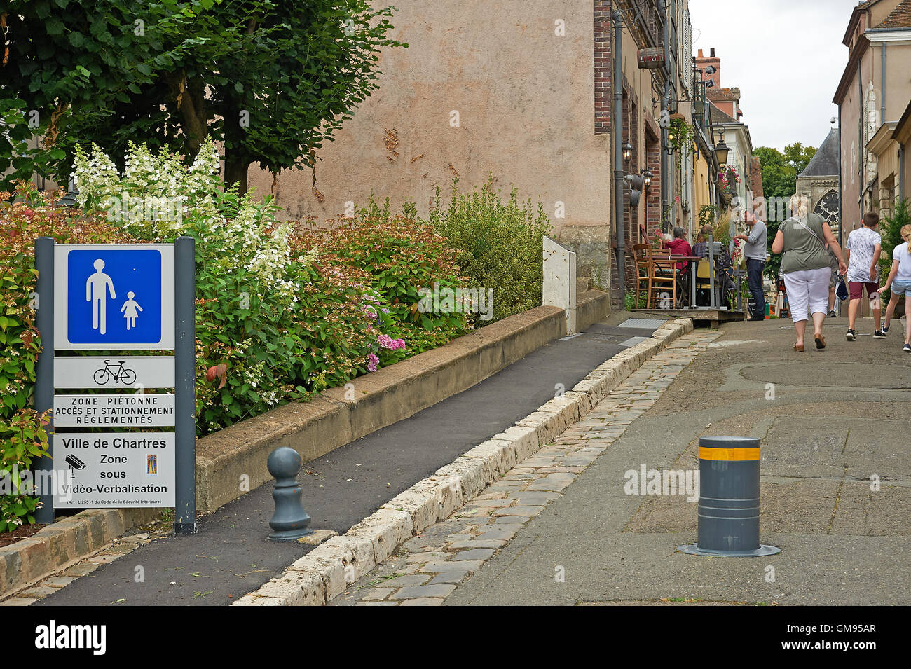 Tourists walk down a pedestrianised street in central Chartres Stock ...