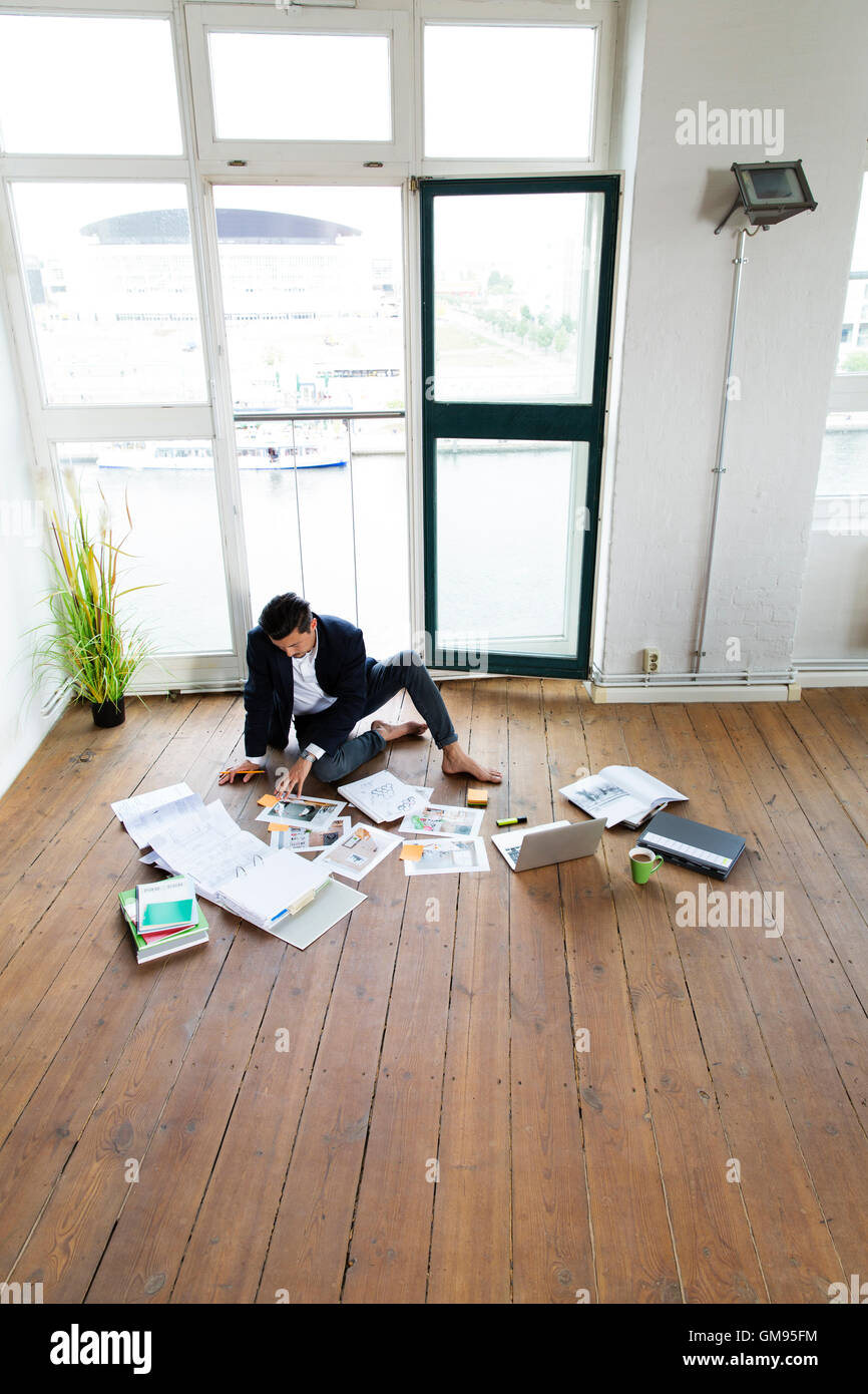 Businessman working barefoot on floor Stock Photo - Alamy