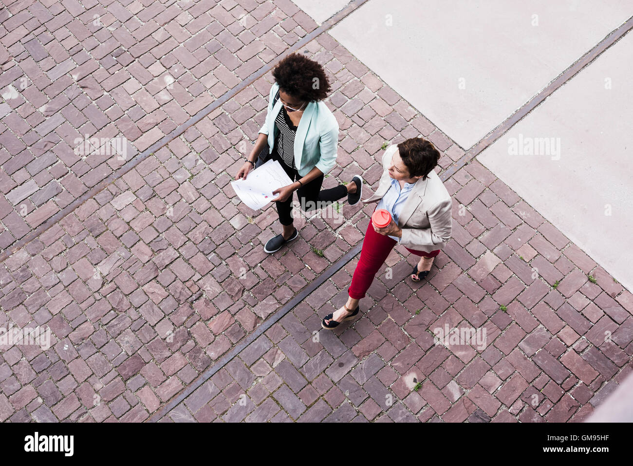 Two businesswomen walking side by side, seen from above Stock Photo - Alamy