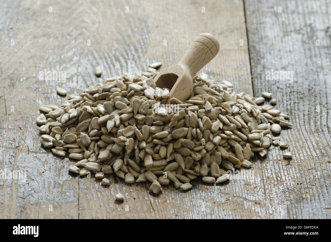 Pile of sunflower seed with wooden shovel Stock Photo - Alamy
