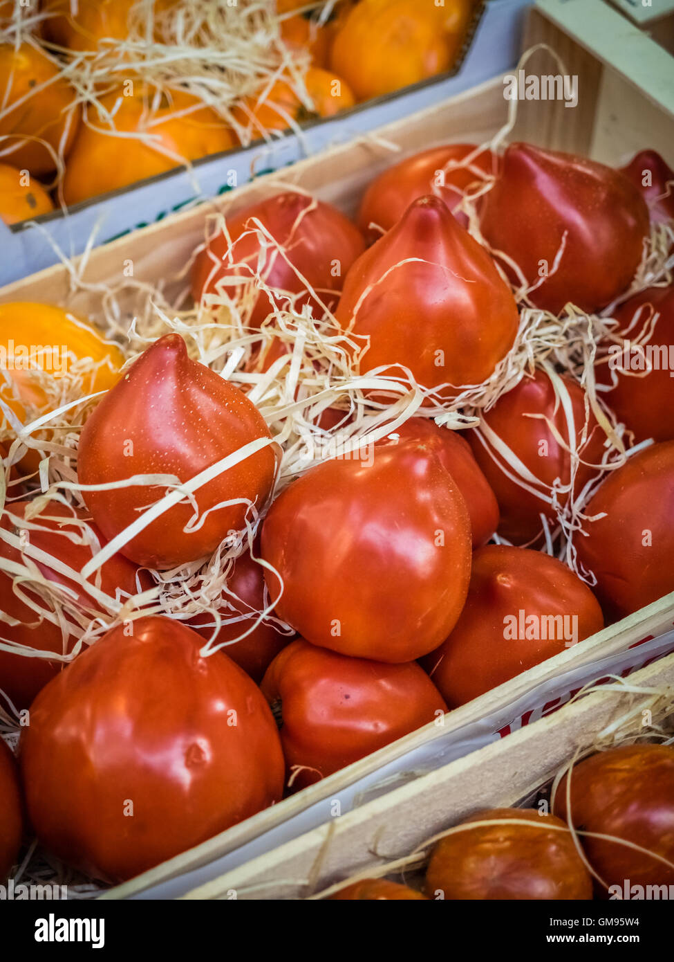 Fresh red ripe tomatoes in wooden baskets on sale on a farmers Borough ...