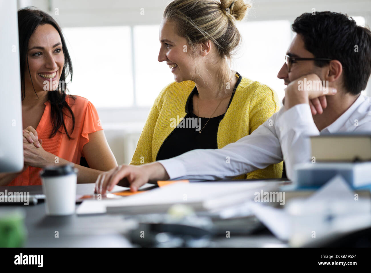 Colleagues in office working together Stock Photo - Alamy