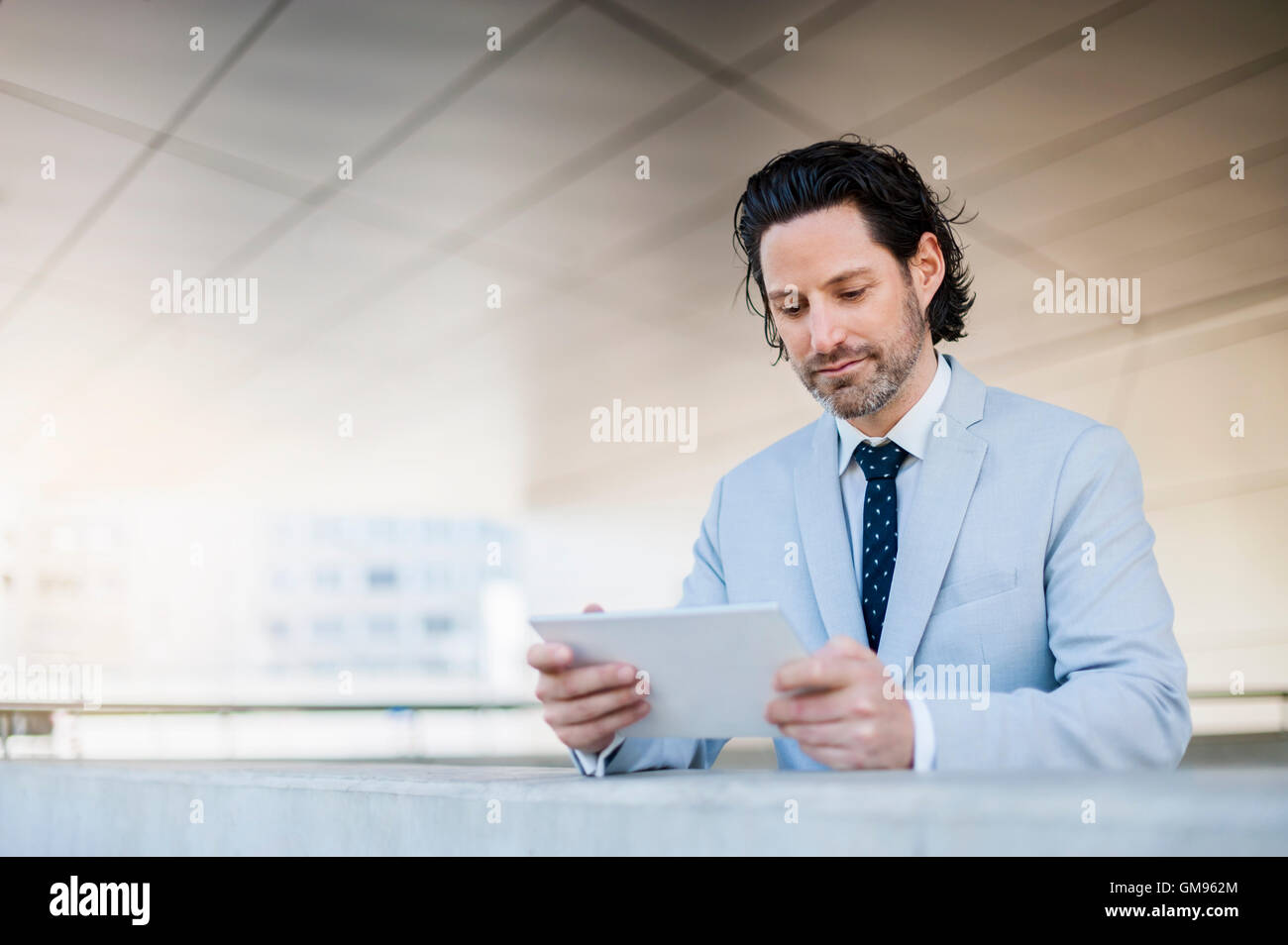 Businessman using tablet Stock Photo - Alamy